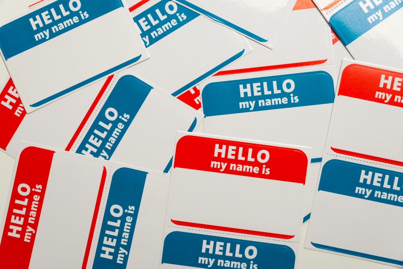 Stack of name tags or badges - True Costs Initiative